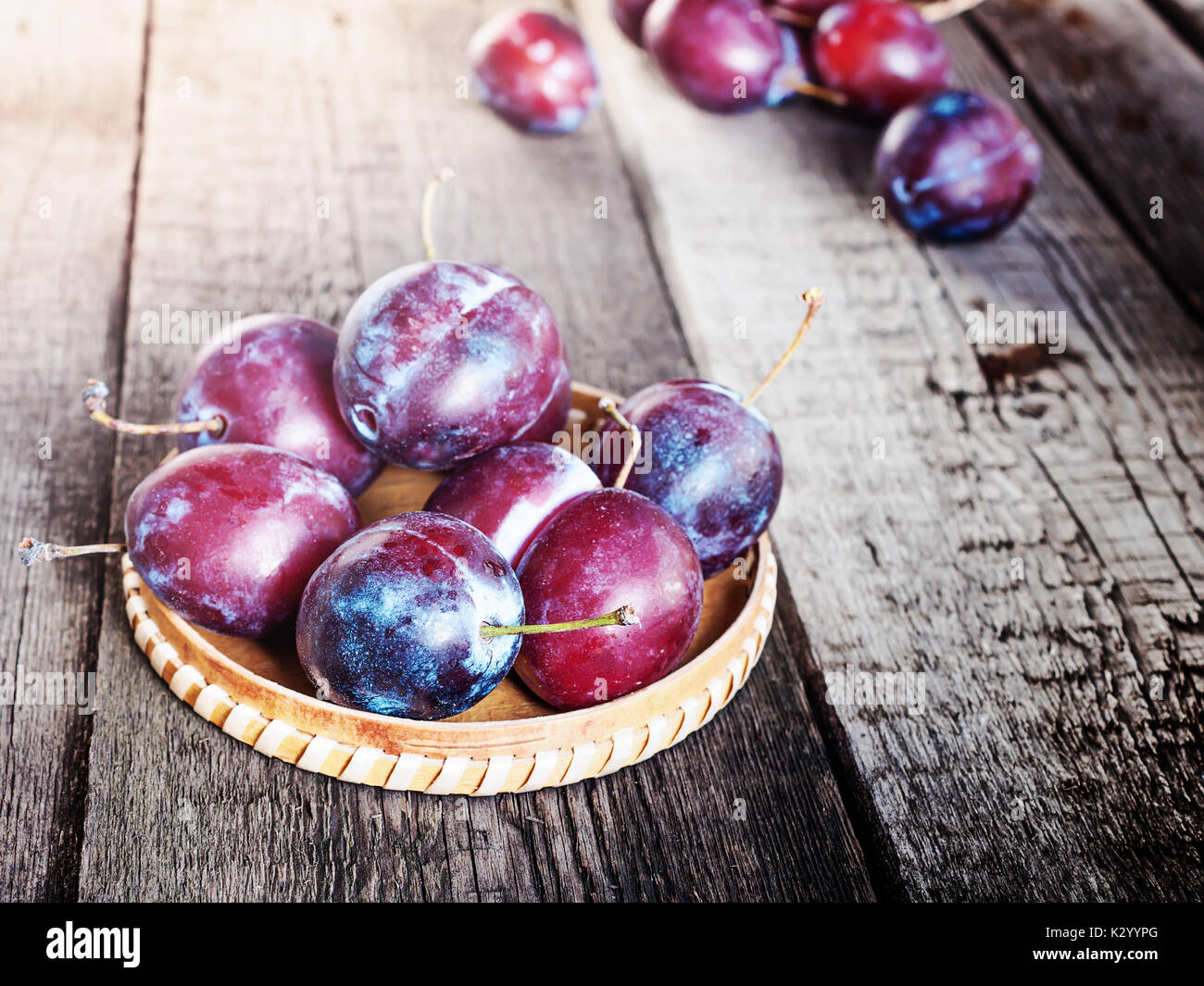 Fresh ripe plum prunes crop harvest, on wood background, organic ...