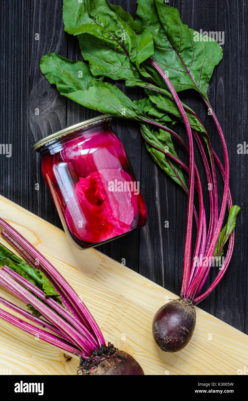 Canned homemade beetroot in clear glass jars with fresh organic ...
