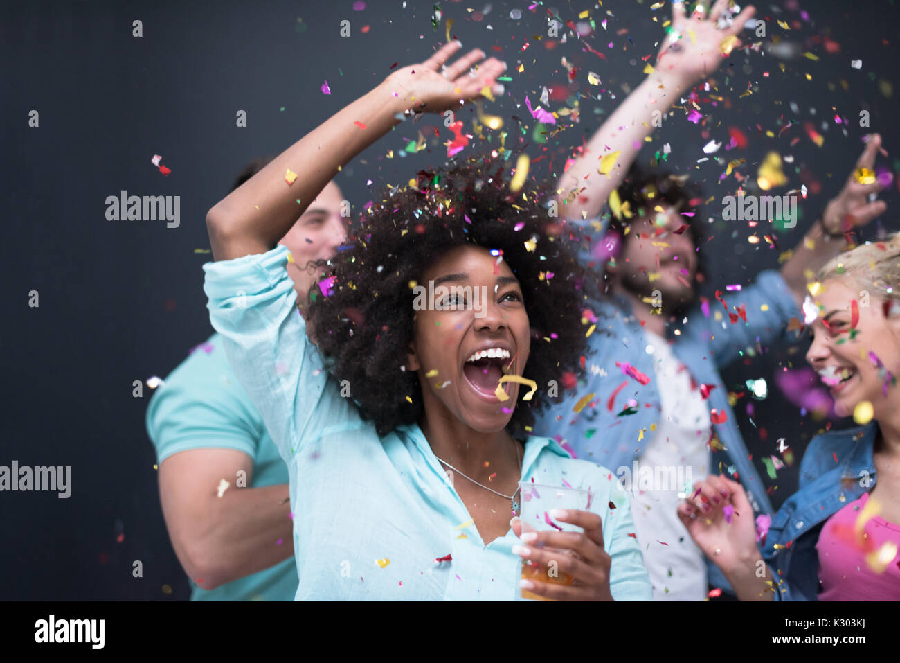 confetti party Multiethnics group of happy young people celebrating new ...