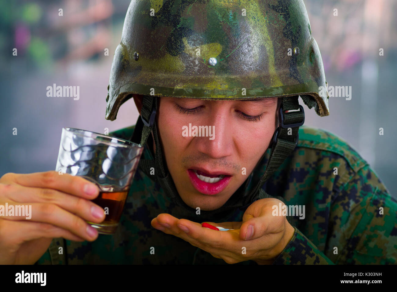 Handsome young soldier wearing uniform suffering from stress post-war ...