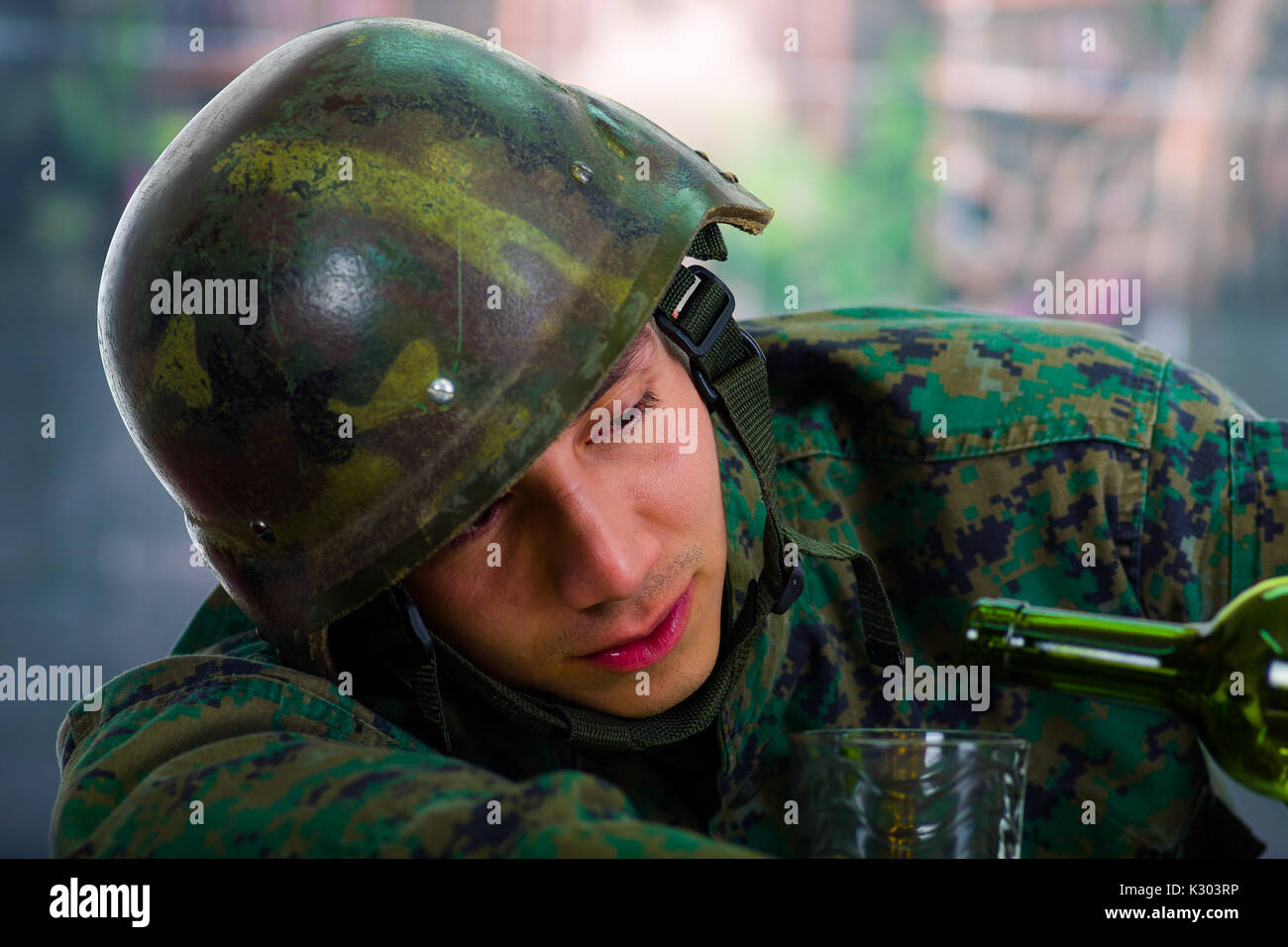 Handsome young soldier wearing uniform suffering from stress post-war ...
