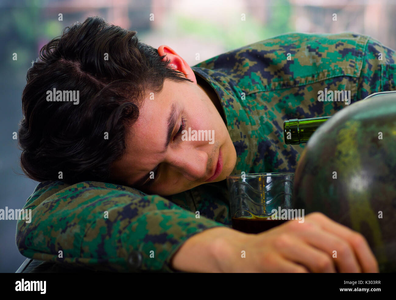 Handsome sleep young soldier wearing uniform suffering from stress post ...