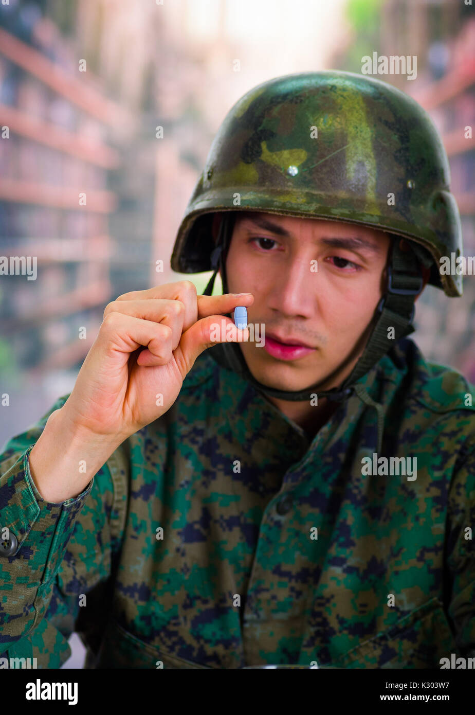 Handsome young soldier wearing uniform suffering from stress post-war ...