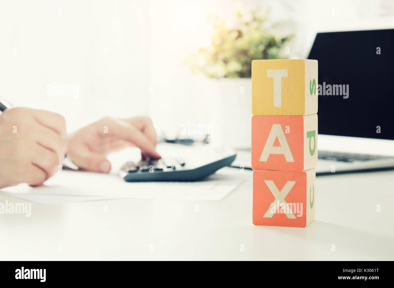 Accountant calculates tax. Working in the office with calculator ...