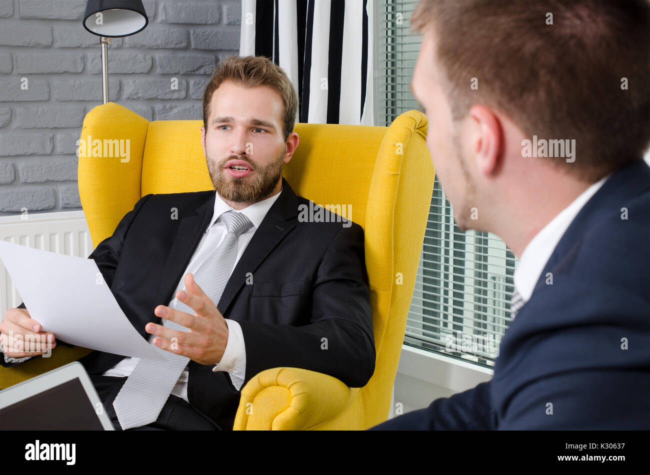 Two focused business partners talking in a modern office Stock Photo ...