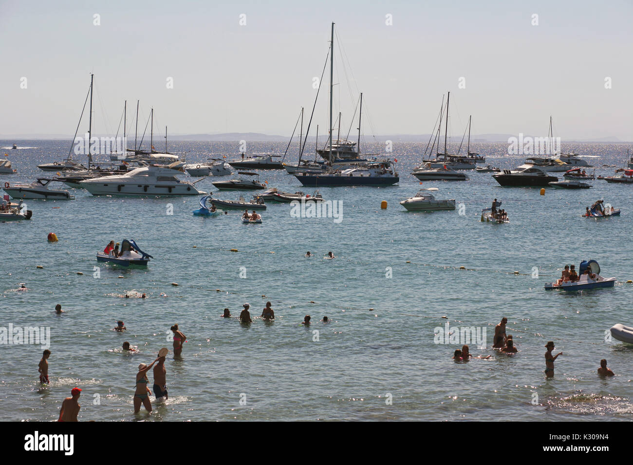 Holidaymakers enjoying the shoreline of the Spanish island of Tabarca ...