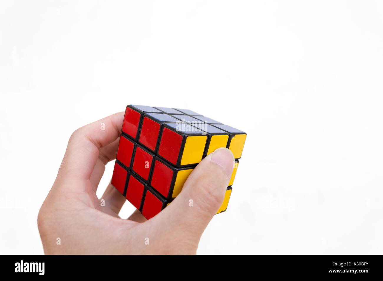 Magic Cube or Rubik's Magic Cube, one hand solving, against white ...