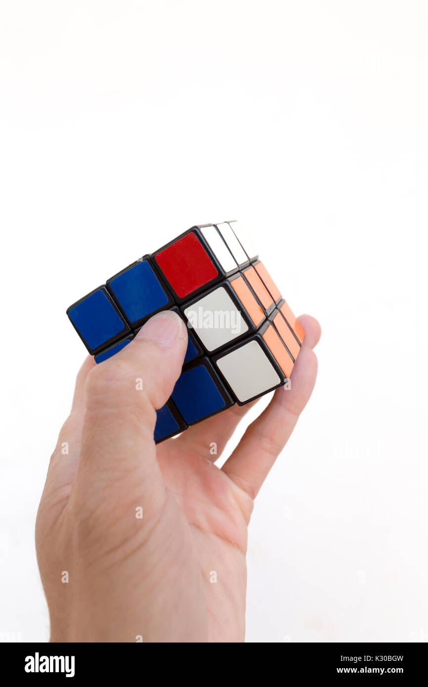 Magic Cube or Rubik's Magic Cube, one hand solving, against white ...