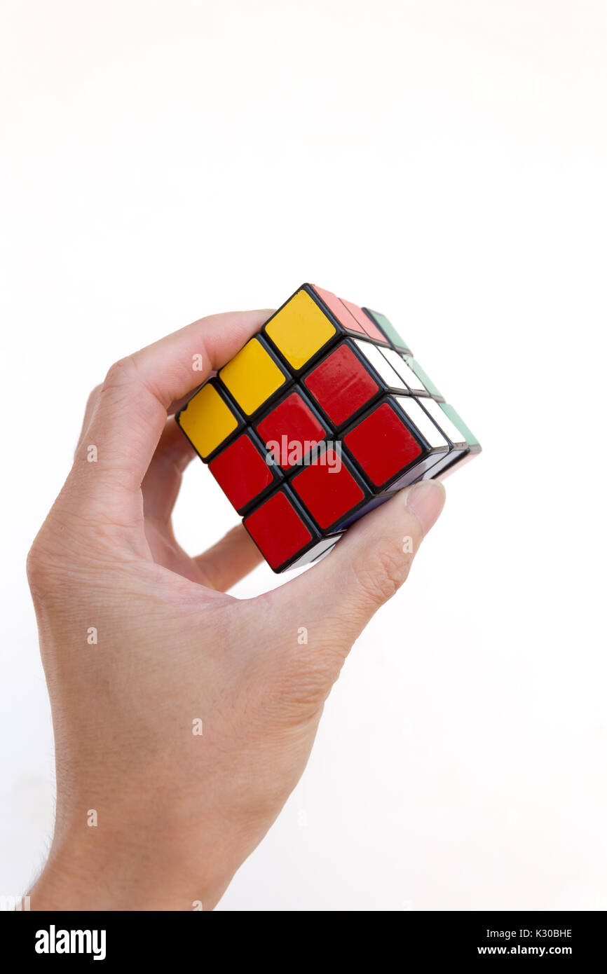 Magic Cube or Rubik's Magic Cube, one hand solving, against white ...