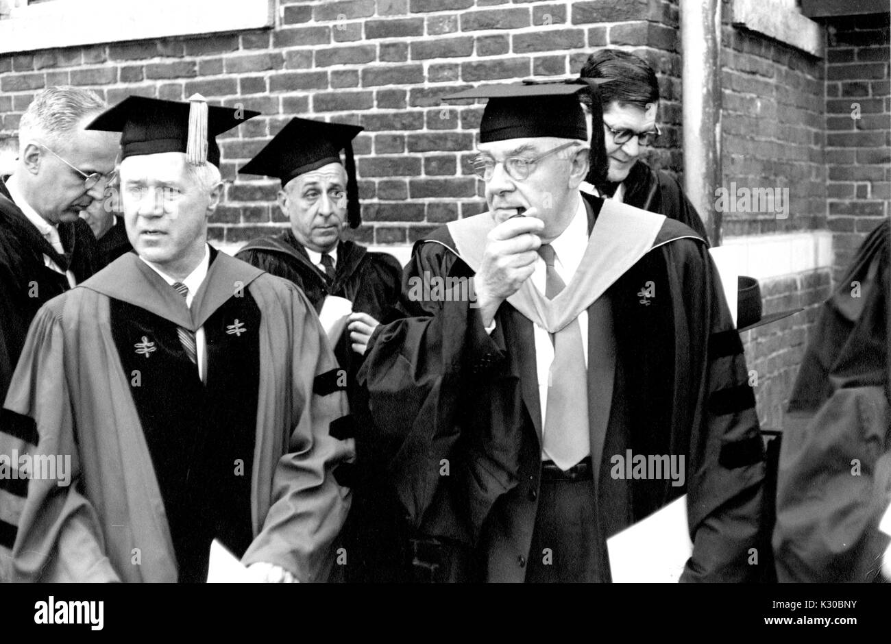 Johns Hopkins University faculty in academic dress stand outside of a ...
