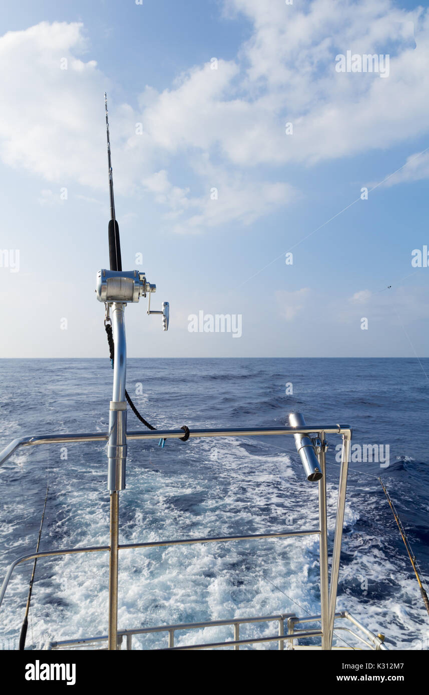 Single rod and reel rig in rail holder on bridge of offshore fishing ...