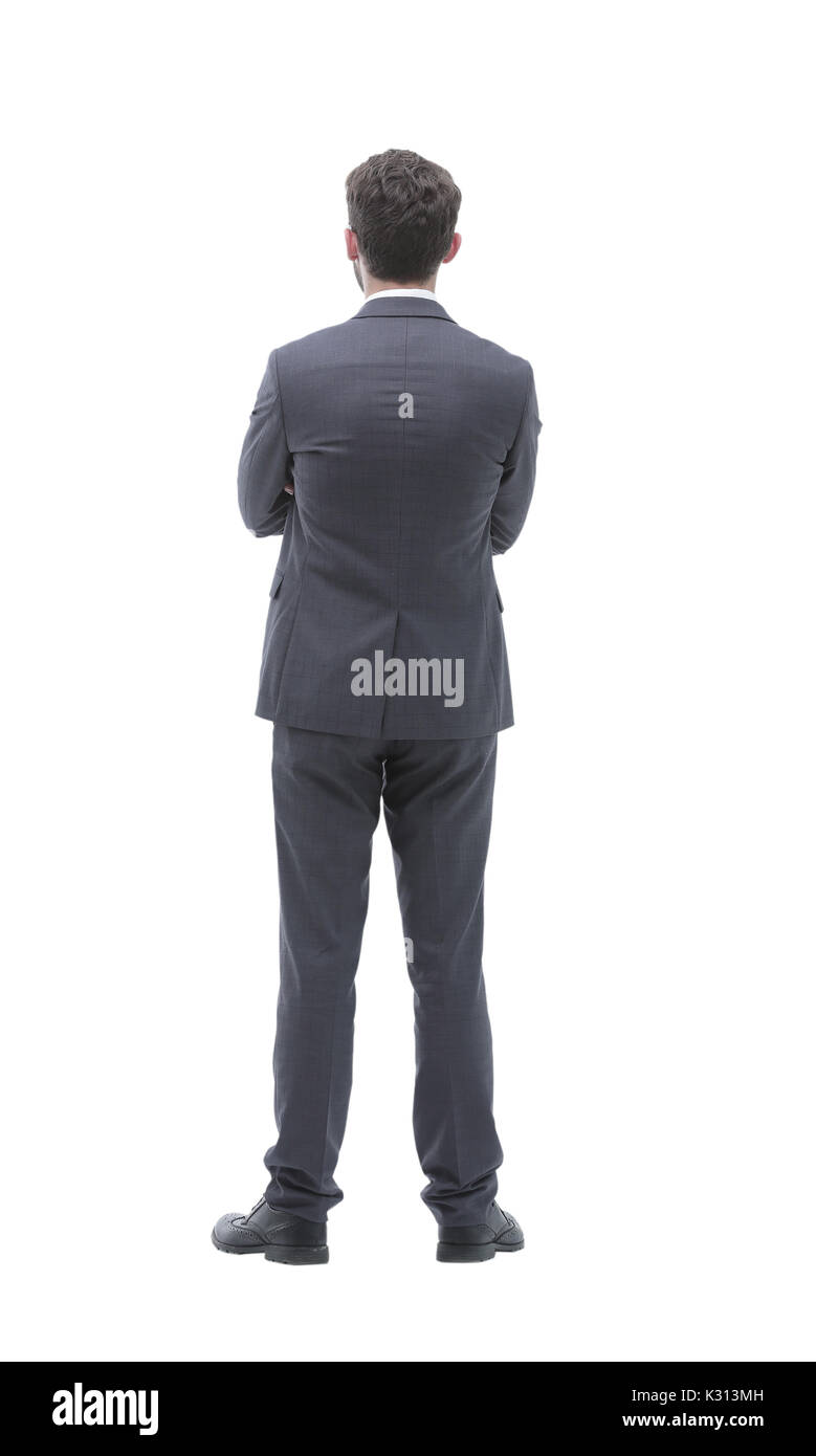 rear view, full-length of a businessman standing and looking forward ...
