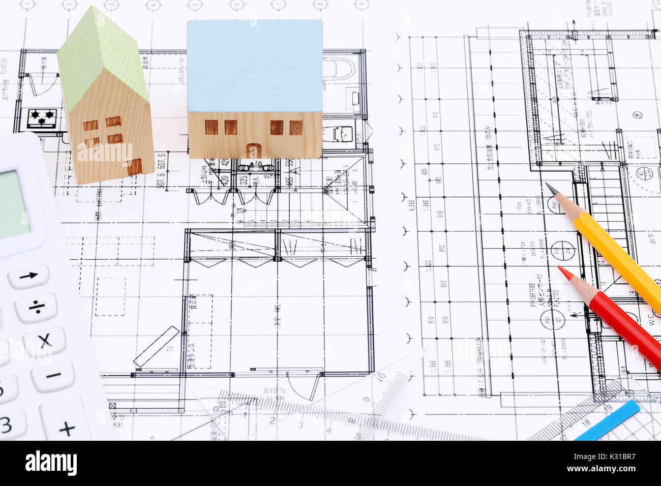 miniature model of house on blueprints, construction plan Stock Photo ...