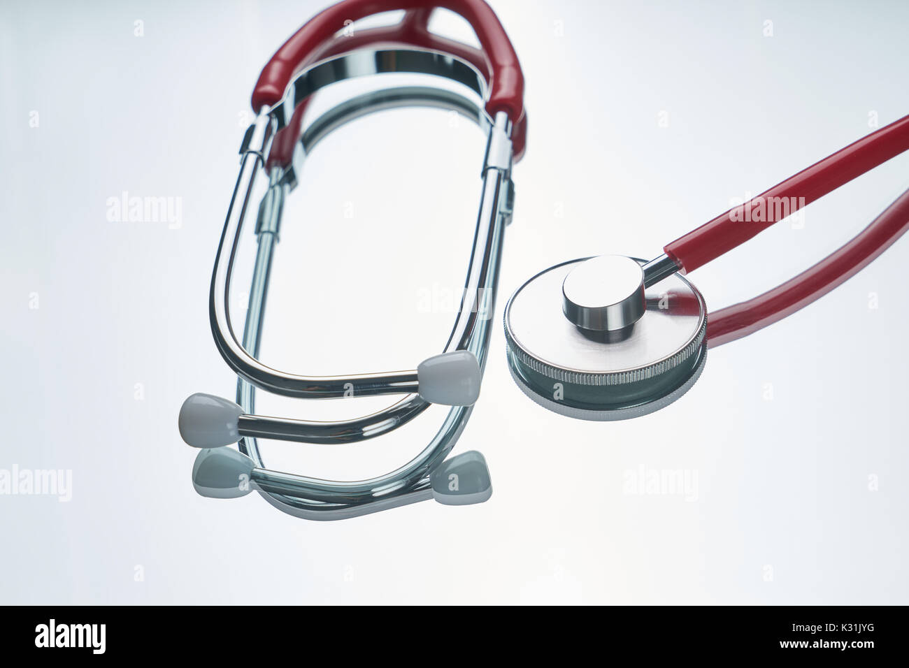 Red color stethoscope with reflection on glossy background Stock Photo ...