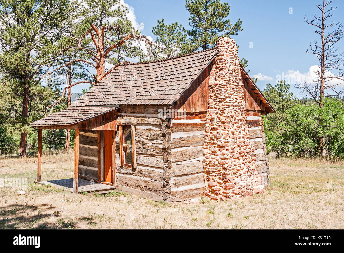 Log cabin built in a clearing by pioneers in the 19th century Stock ...