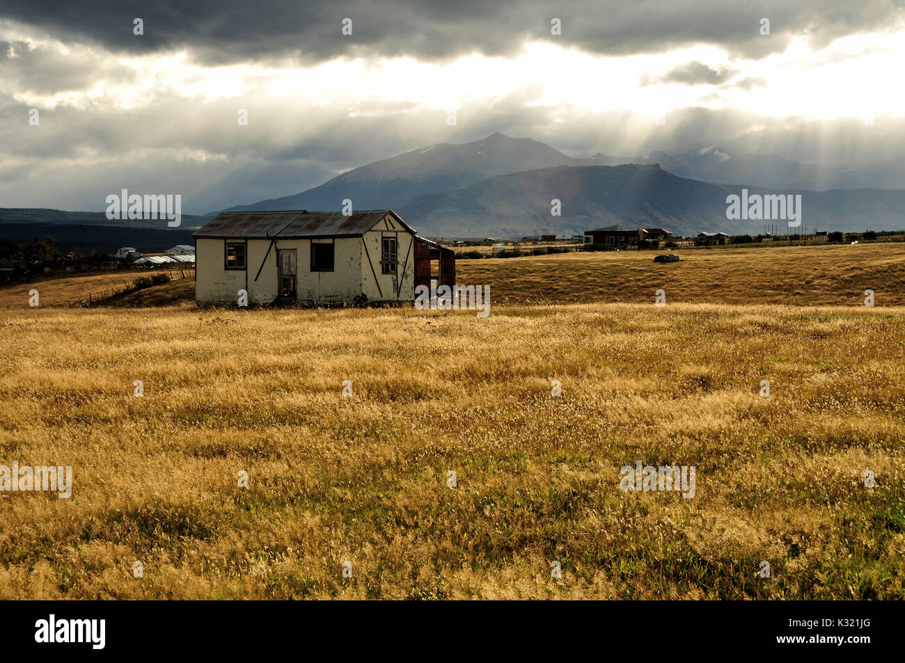 simple farm house fallen into disrepair, surrounded by grass fields at ...