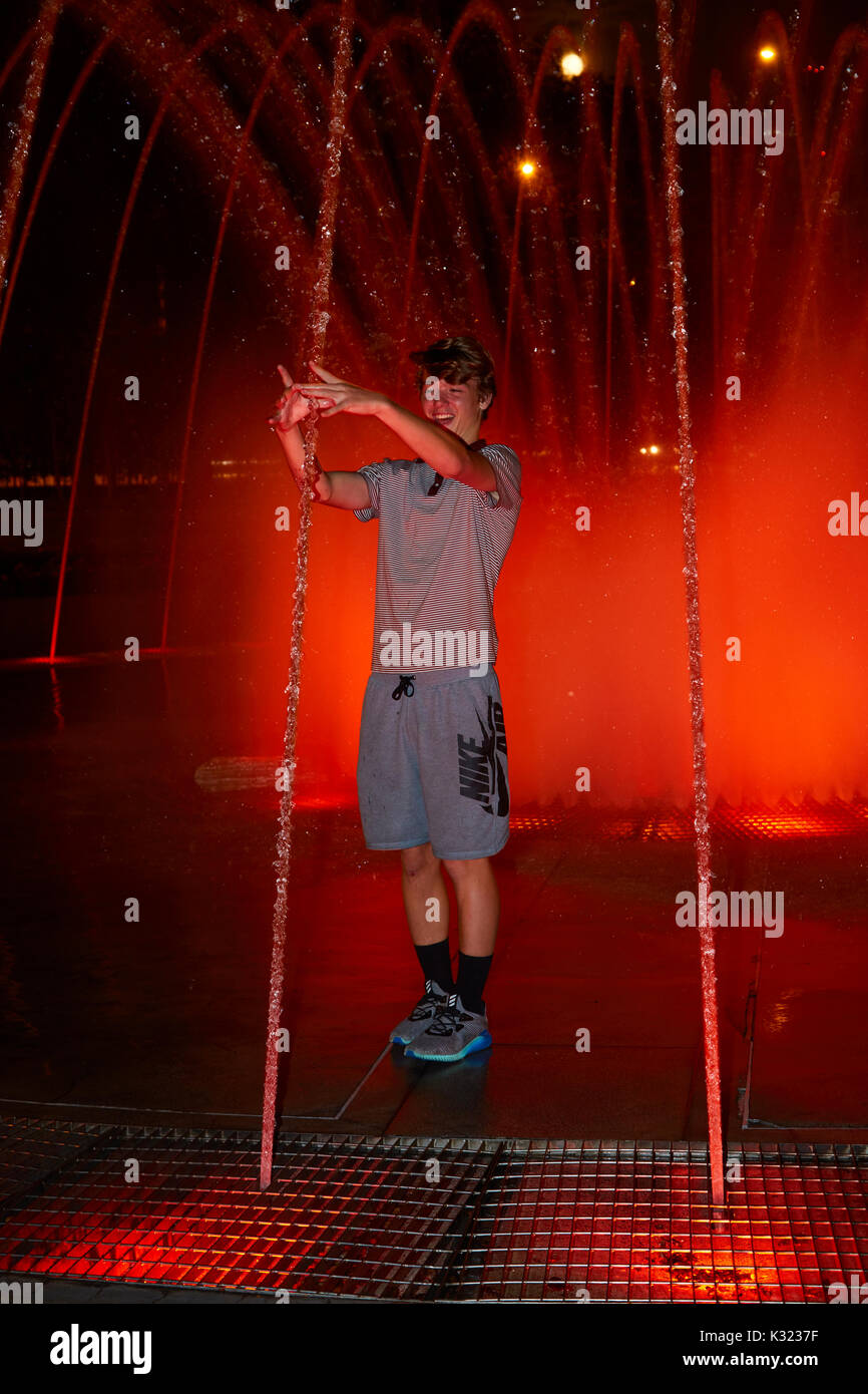 Teenager at Walk-in Dome Fountain at the Magic Water Circuit (world's ...