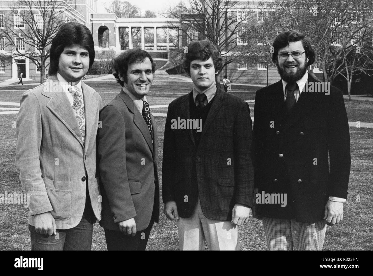 Two Johns Hopkins students and two professors dressed in suits standing ...