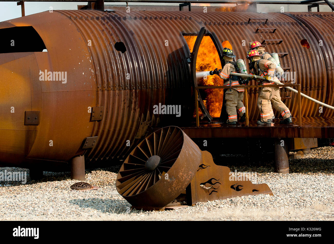 Firemen with the 5th Civil Engineer Squadron put out a fire on a B-52H ...
