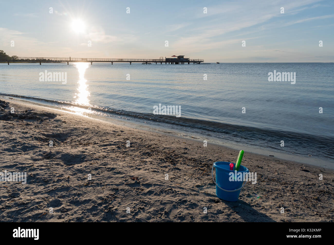 Evening by a sand beach with bath pier and toys at the swedish island ...