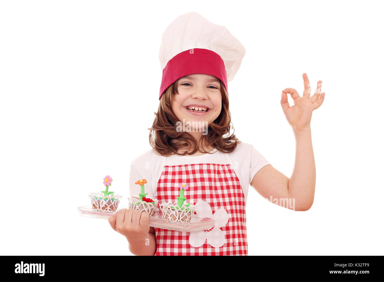 happy little girl cook with spring flowers muffins and ok hand sign ...