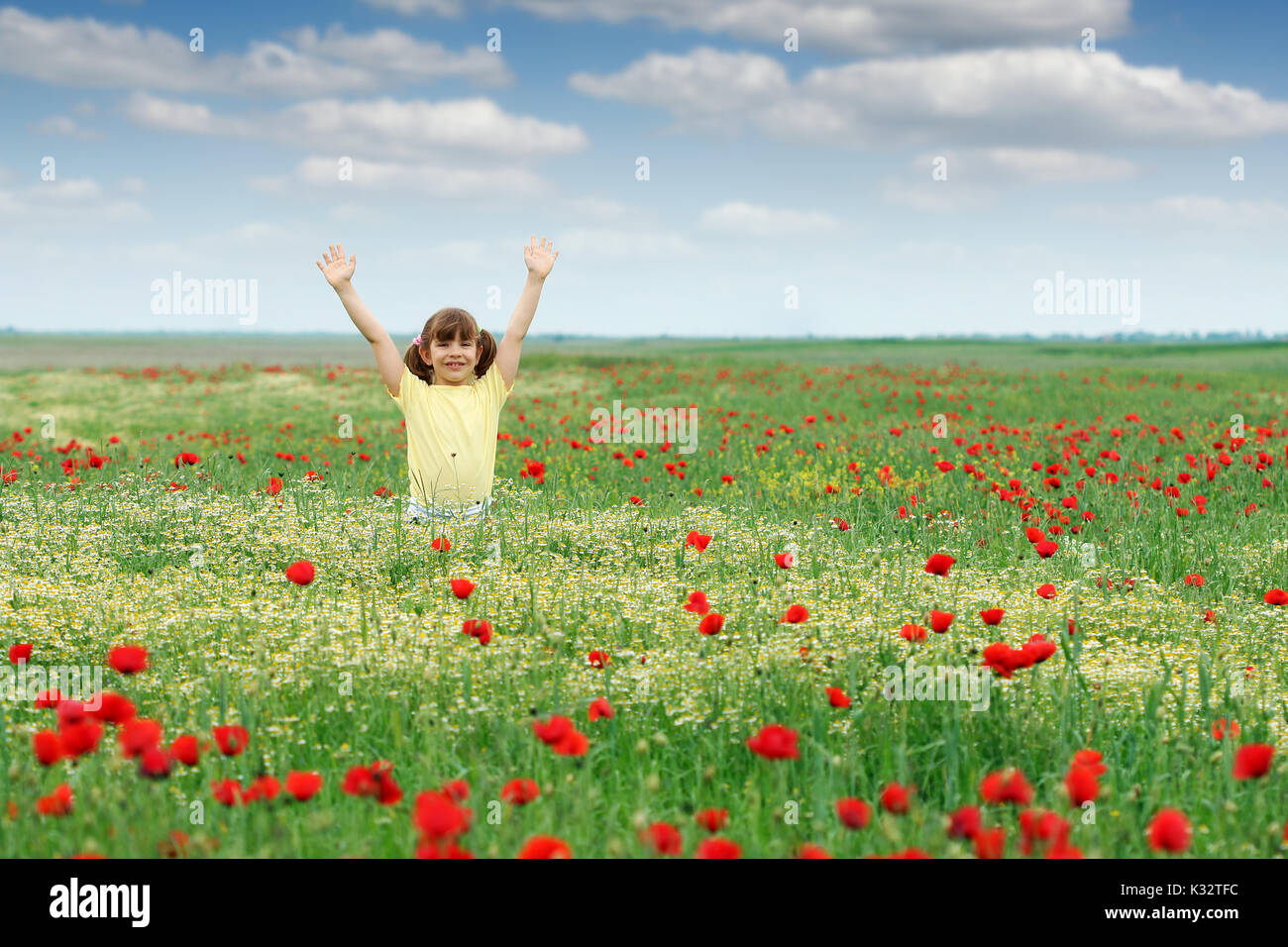 happy little girl on spring meadow Stock Photo - Alamy