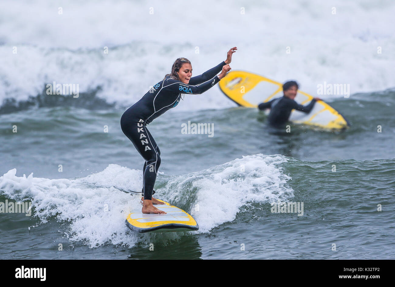 Surfing at Waikiki Beach in the tourist area of Miraflores in the ...