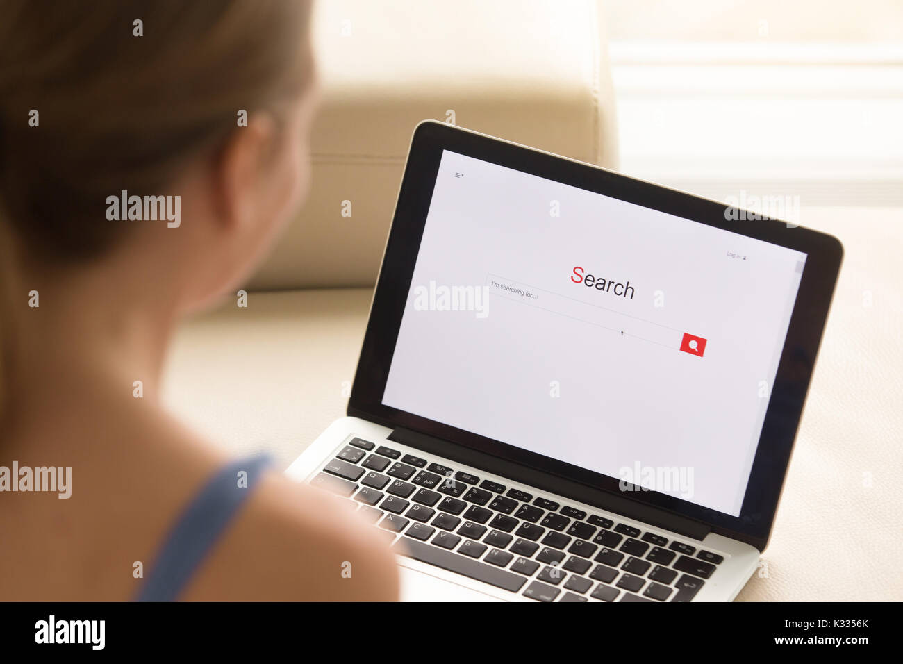 Woman searching information online with laptop Stock Photo - Alamy