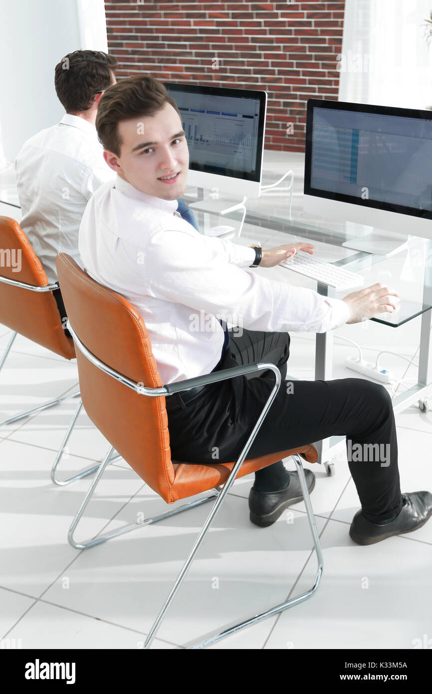 office life.employees sitting behind a Desk Stock Photo - Alamy