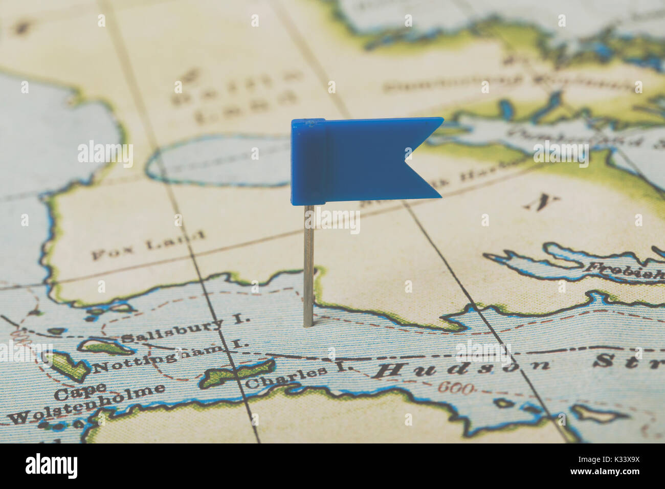 Flag shaped push pin in a vintage travel map. travel destination ...