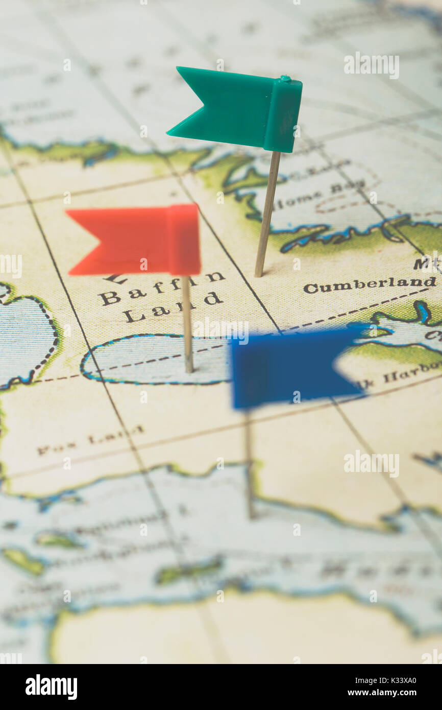 Flag shaped push pin in a vintage travel map. travel destination ...