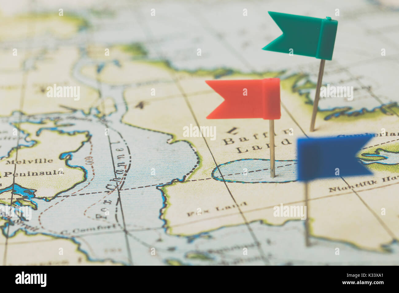 Flag shaped push pin in a vintage travel map. travel destination ...