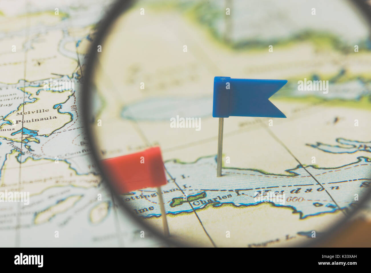 Flag shaped push pin in a vintage travel map. travel destination ...