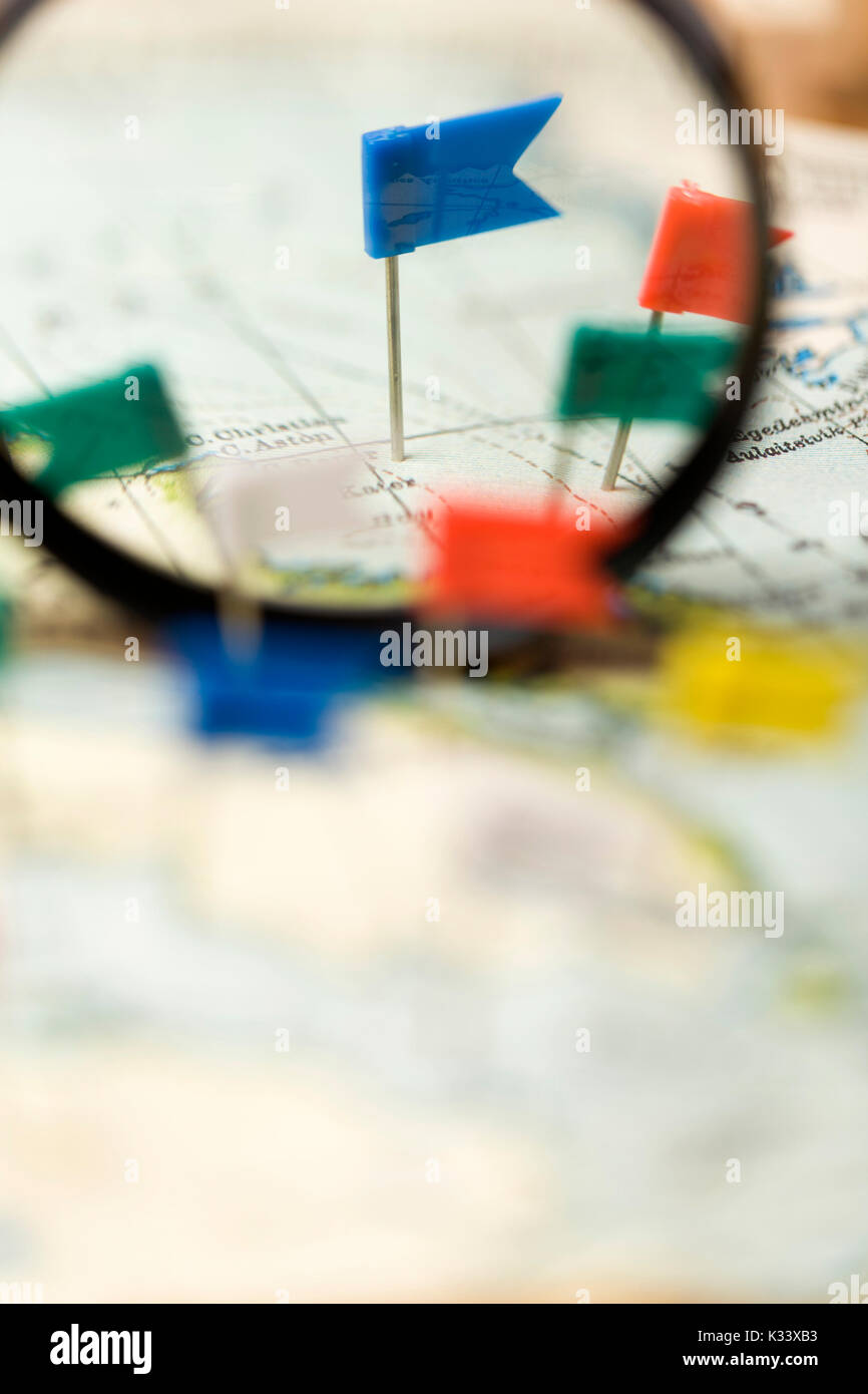 Flag shaped push pin in a vintage travel map. travel destination ...