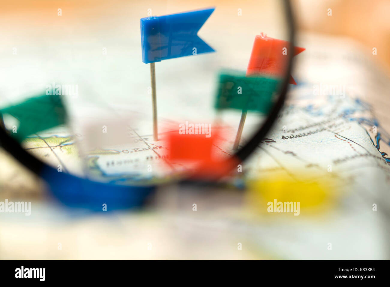 Flag shaped push pin in a vintage travel map. travel destination ...
