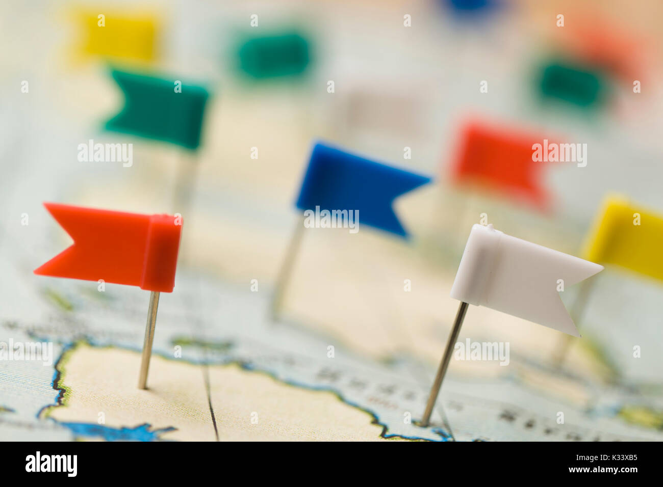 Flag shaped push pin in a vintage travel map. travel destination ...
