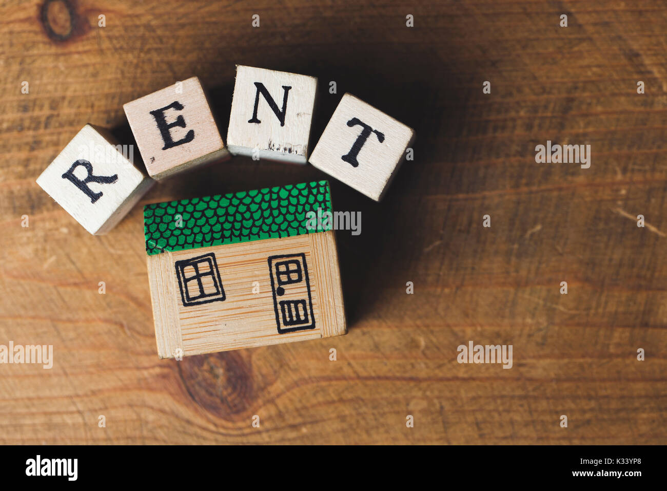 Home rent concept. House model with rent word made from wooden blocks ...