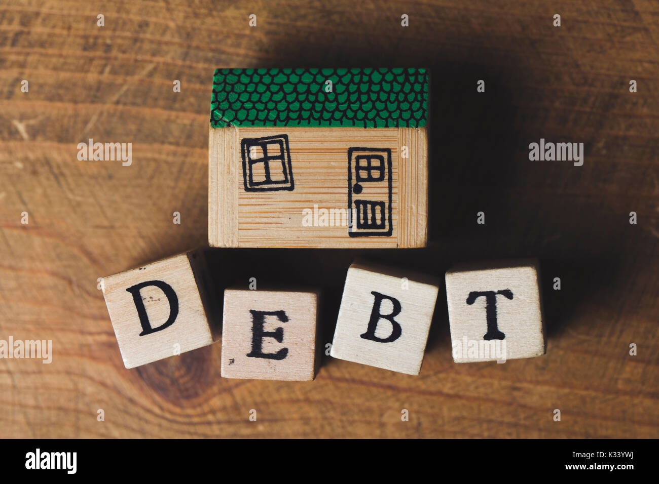 Home debt concept. House model with debt word made from wooden blocks ...