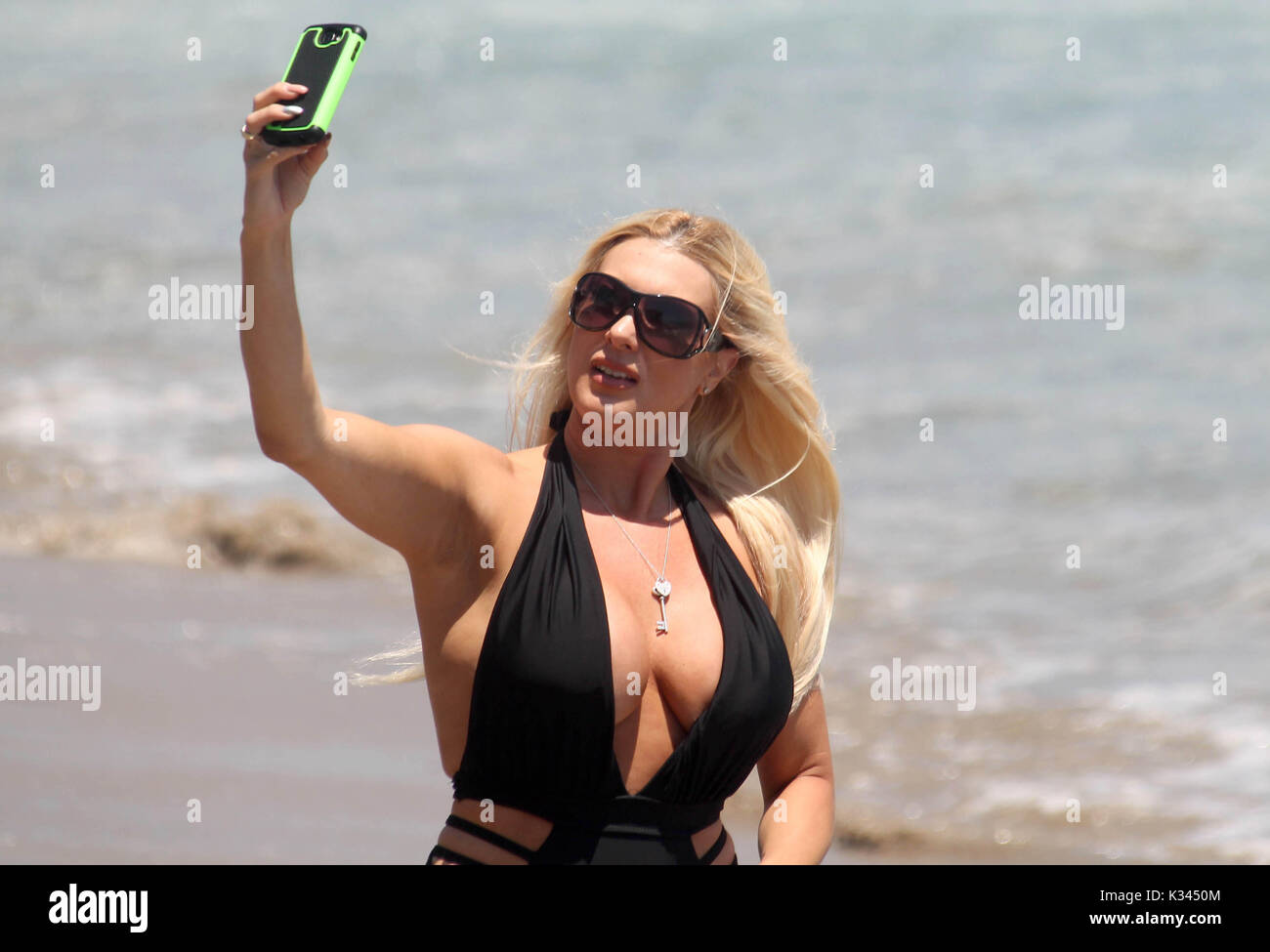 Australian burlesque magician Suzie Malone tries to take the perfect selfie on Malibu Beach ...