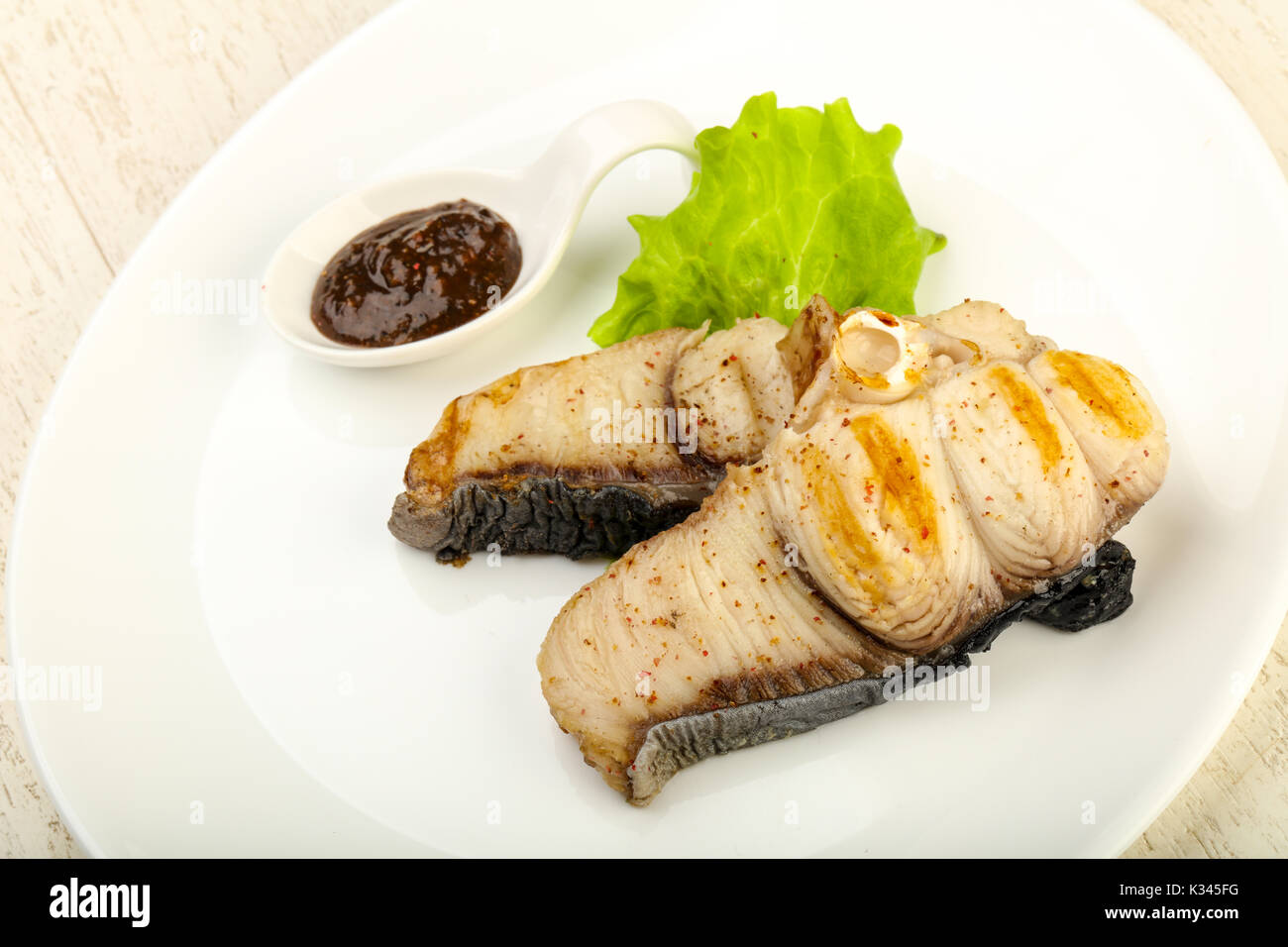 Grilled shark steak with pepper sauce and salad leaves Stock Photo - Alamy
