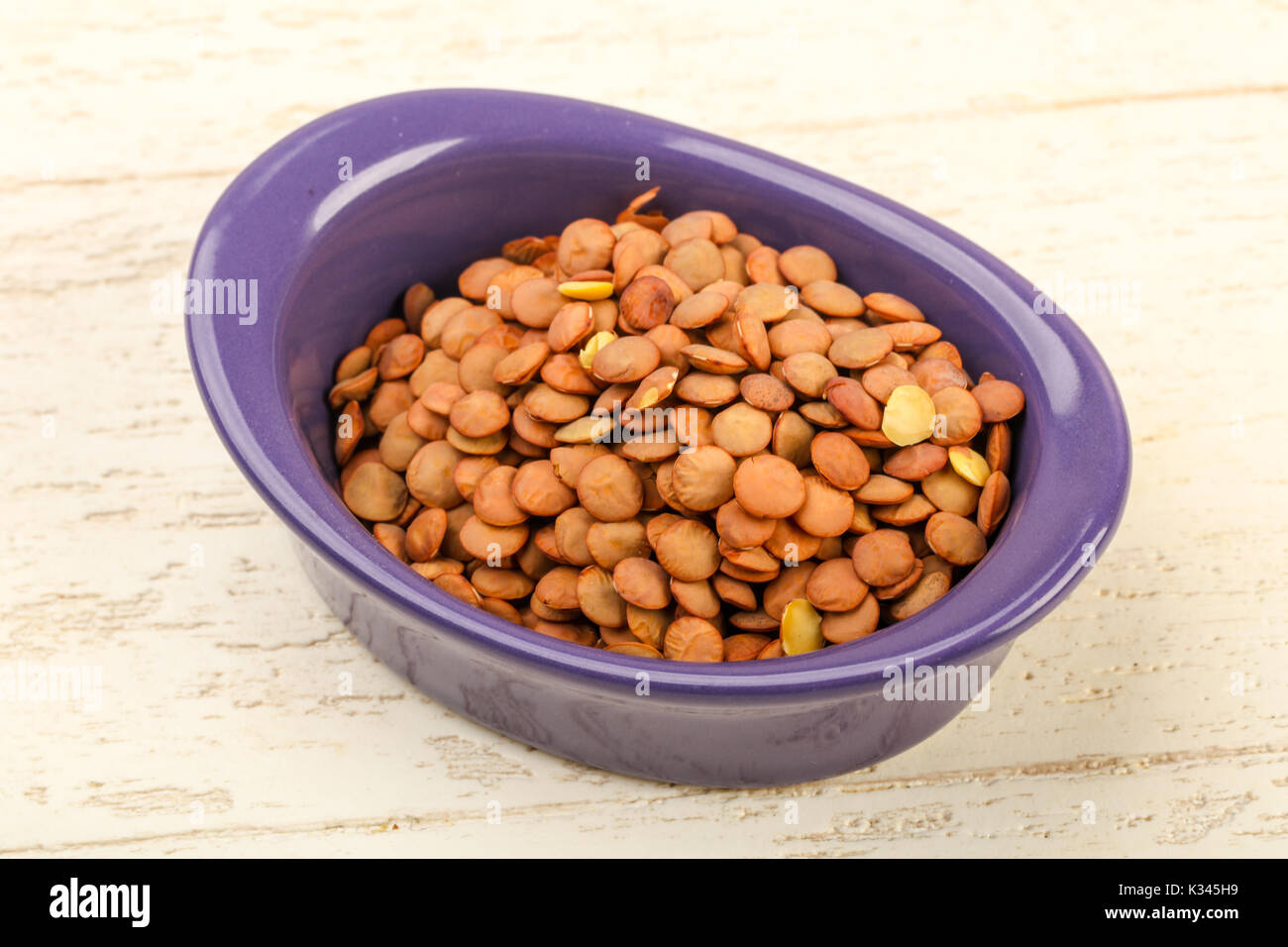 Raw lentils in the bowl ready for cooking Stock Photo - Alamy