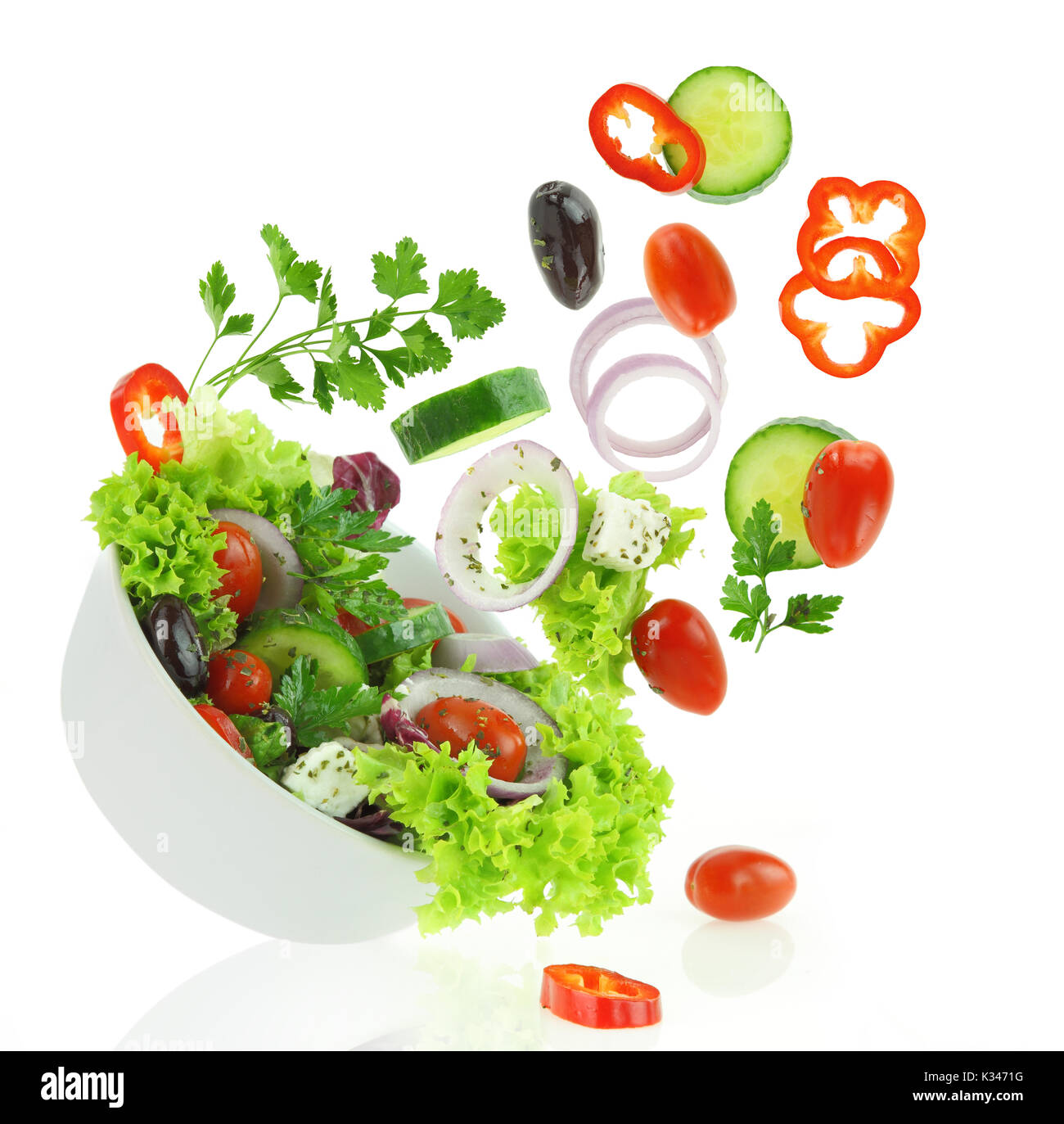 Fresh mixed vegetables falling into a bowl of salad Stock Photo - Alamy