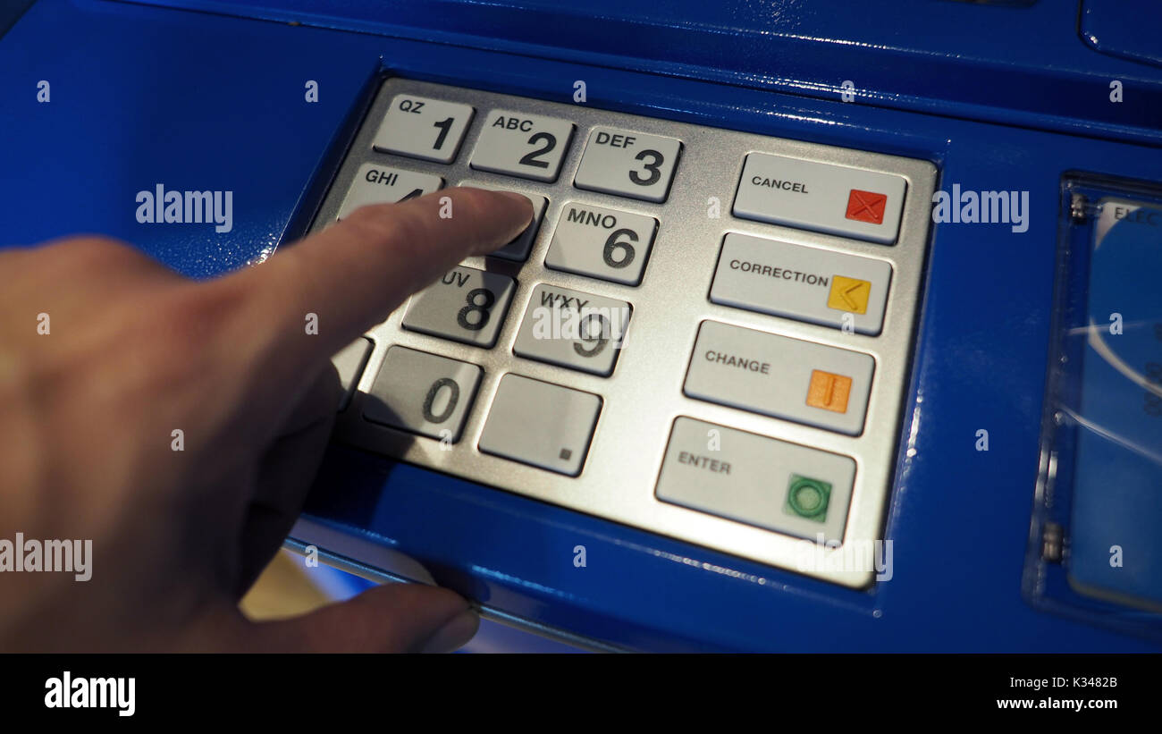 Blue color banking ATM machine and black number on white button keypad ...