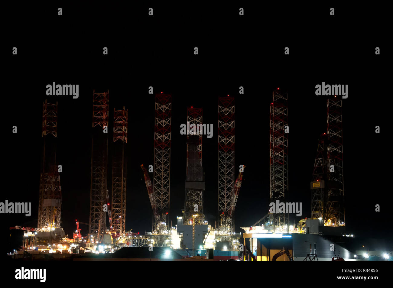 Oil rig platforms at night Stock Photo - Alamy