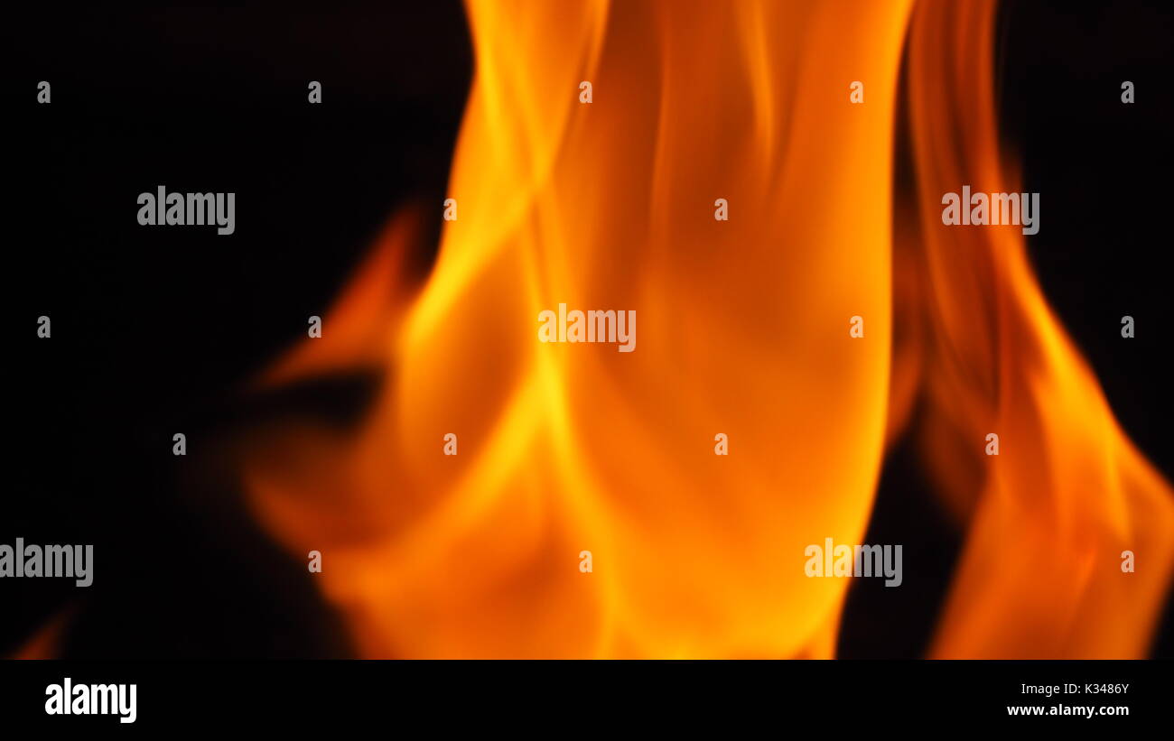 Fire for cooking is blazing dangerously close-up and yellow color on ...