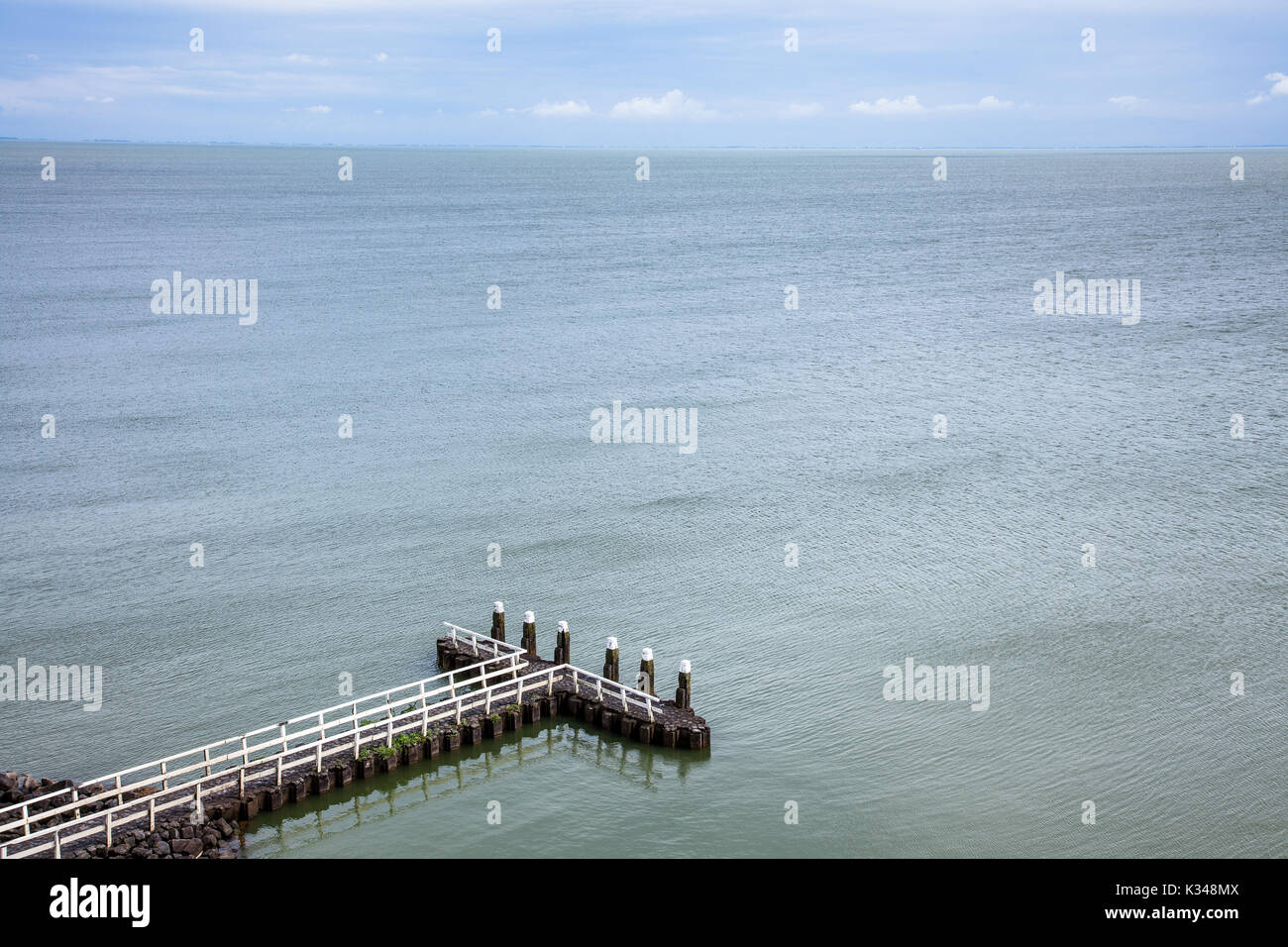 stone pier with a white railing Stock Photo - Alamy