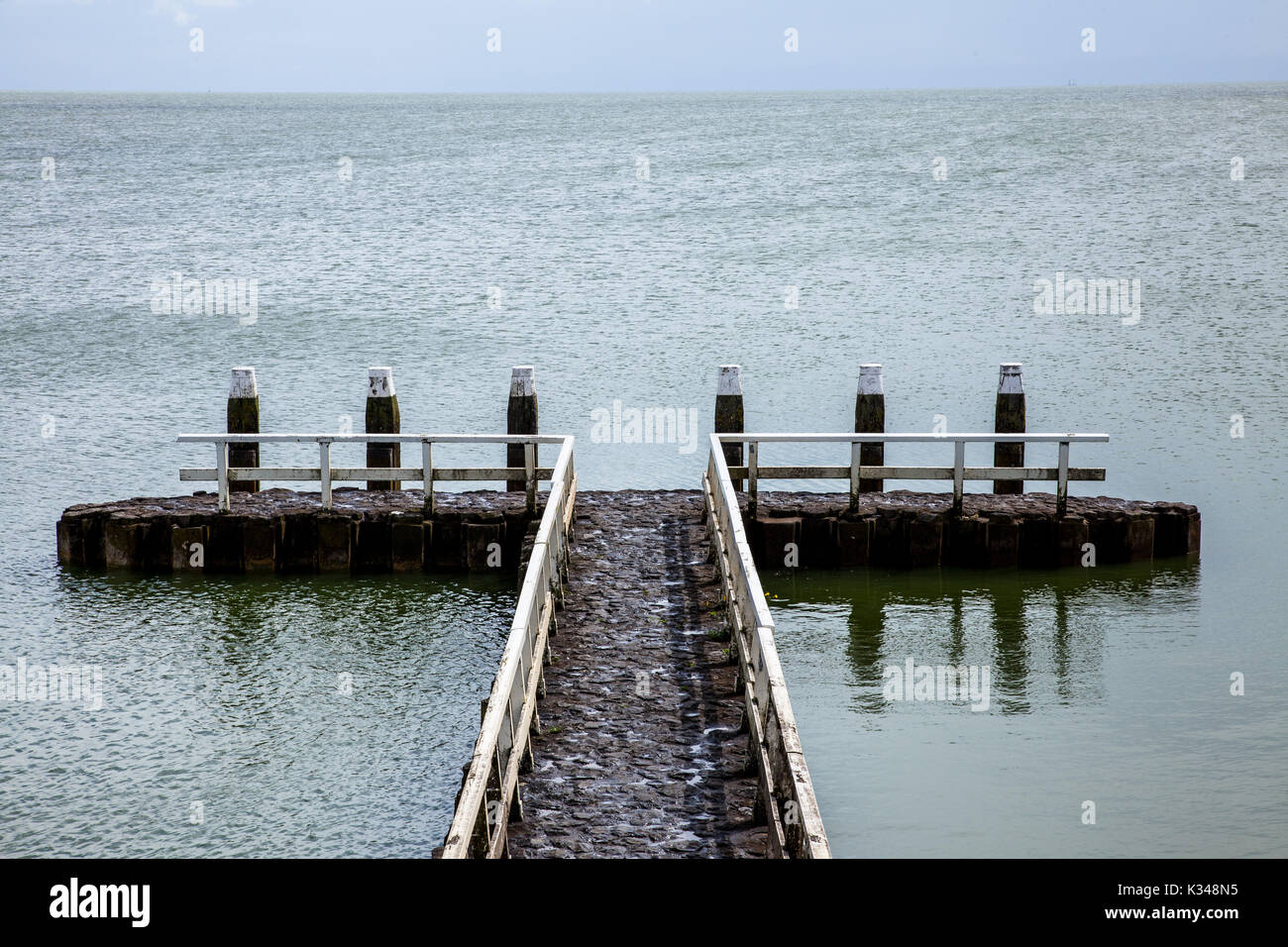 stone pier with a white railing Stock Photo - Alamy