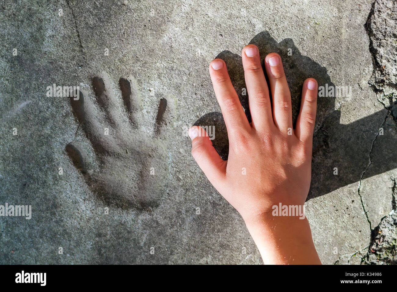 Childs hand and memorable handprint in concrete Stock Photo - Alamy