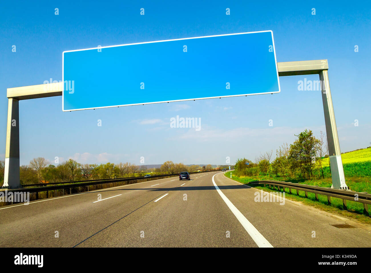 Blank blue freeway sign over the road on sunny day Stock Photo - Alamy