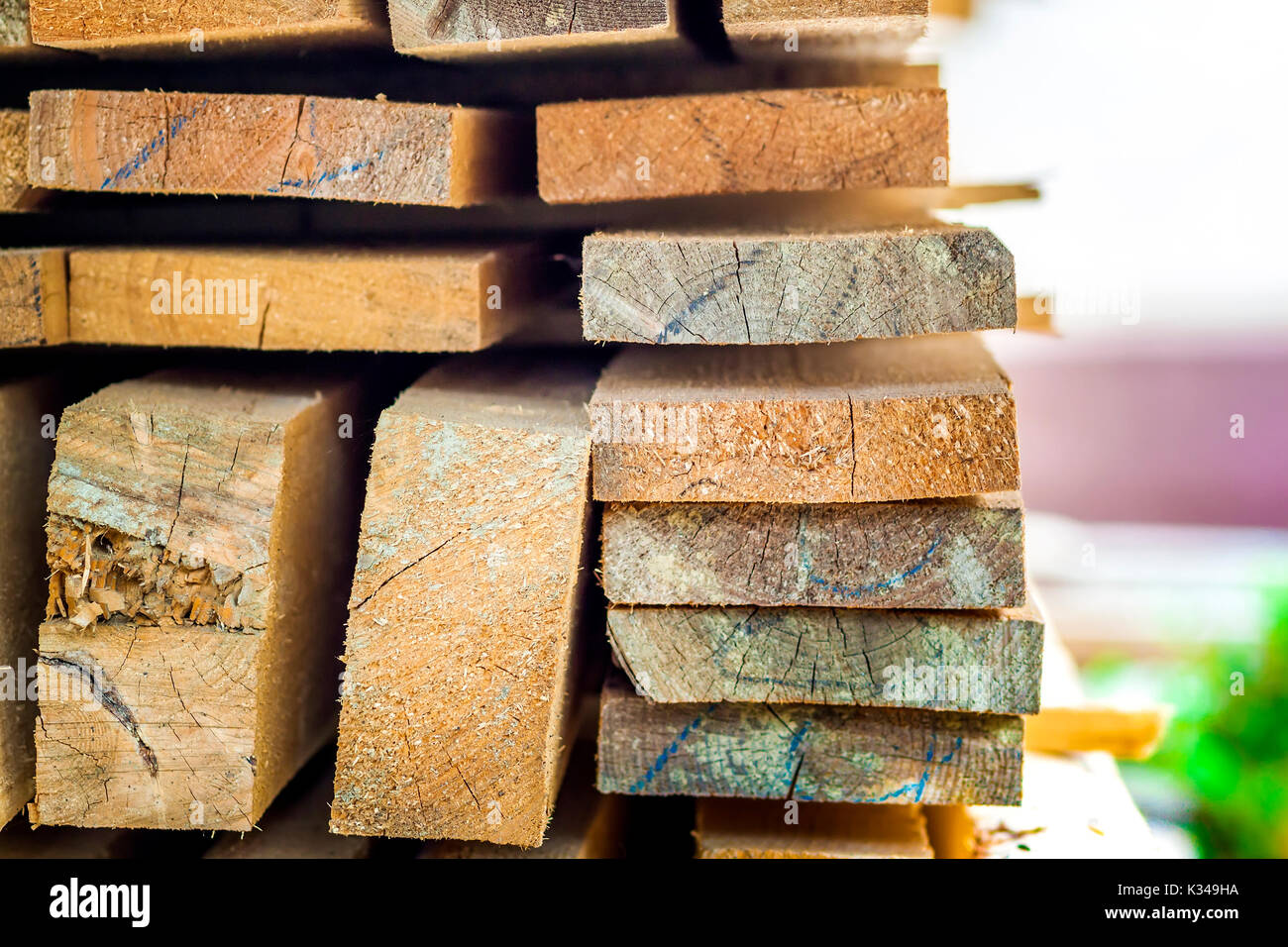 Stack of building lumber at construction site with narrow depth of ...